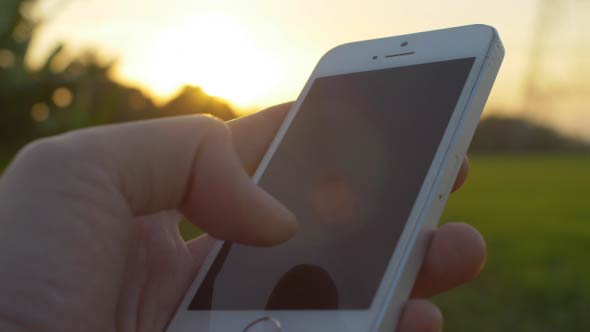 Using Mobile Phone at Sunset, Stock Footage | VideoHive
