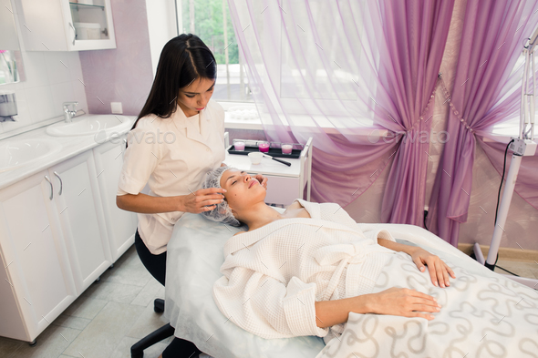 Woman cosmetologist to work in beauty salon Stock Photo by romankosolapov