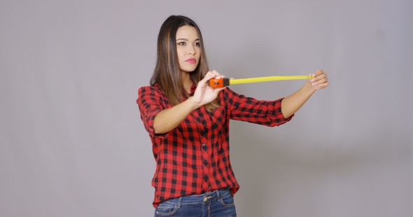 Laughing DIY Woman Holding Up a Tape Measure, Stock Footage | VideoHive
