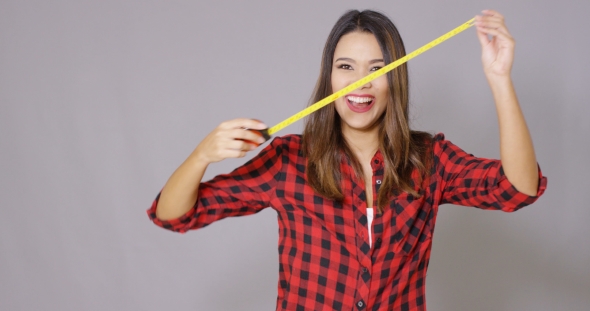 Laughing DIY Woman Holding Up a Tape Measure, Stock Footage | VideoHive