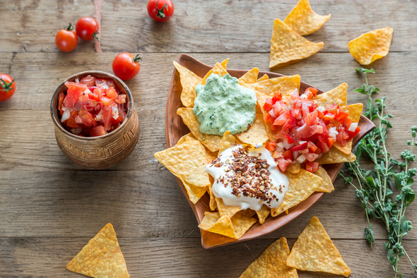Cheese nachos with different types of sauce Stock Photo by Alex9500