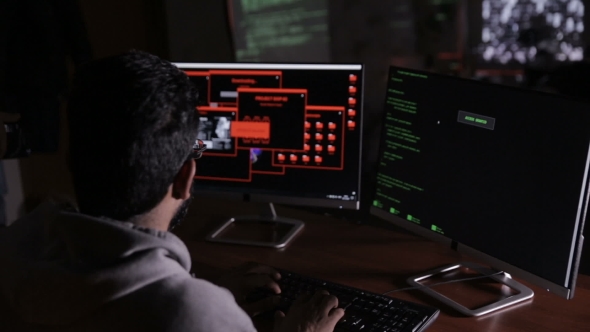 Male Arabic Hacker Hacks Computer In Dark. Computer Code Reflecting On ...