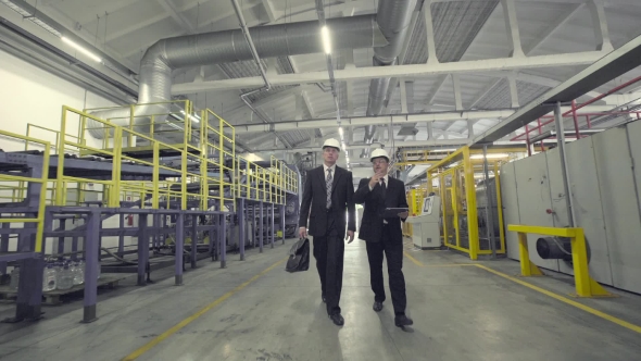Two Businessmen Walking Through Factory, Stock Footage | VideoHive