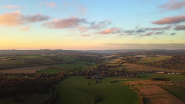 Aerial view of a sunset over English countryside with fields and ...