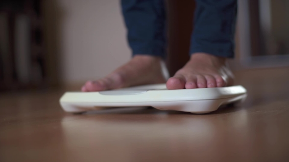 Young Woman Measuring Body Weight On Weighing Scale At Home, Stock Footage
