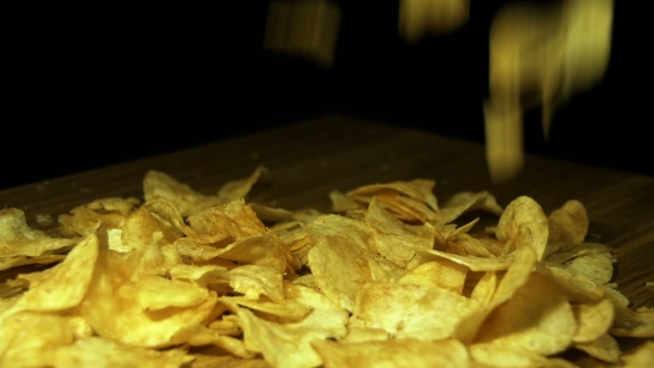 Potato Chips Are Falling on a Wooden Table, Stock Footage | VideoHive