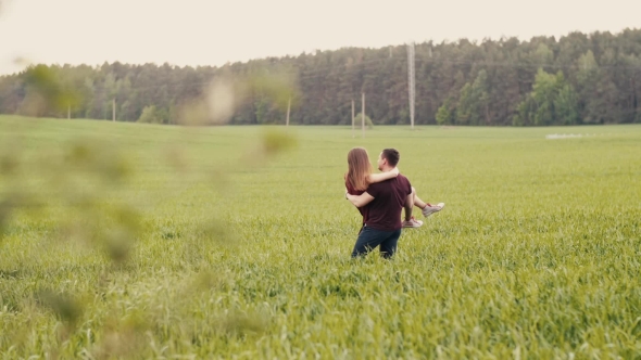 Loving Couple Swirl Around in a Field. Happy Man and Woman Look at Each ...