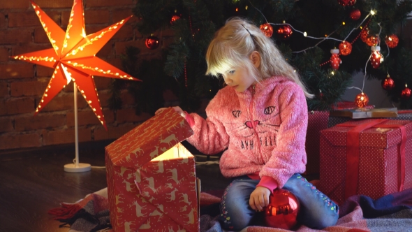 Little Cute Girl Looking Inside of Glowing Christmas Present Box, Stock ...