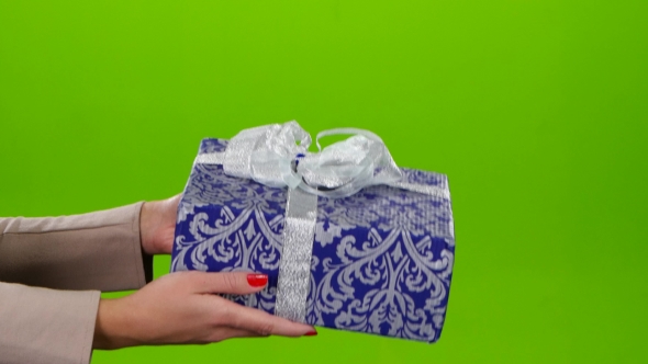 Box with a Gift Lovingly Packed in Blue Paper with Ornament, Stock Footage