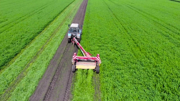 Aerial Footage of a Modern Tractor Plowing Dry Field, Preparing Land ...
