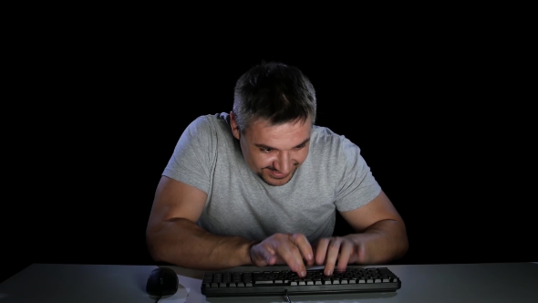 Man Excitedly Looking at a Computer Monitor. Dark Studio, Stock Footage