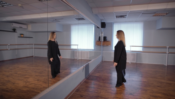 Beautiful Woman Gracefully Dancing in Front of a Mirror and Looking at ...
