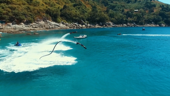 Aerial: Diving on Flyboard Near the Beach, Stock Footage | VideoHive