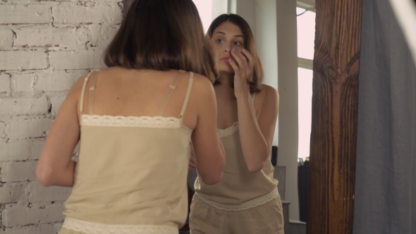 Female Looks on Reflection in Mirror., Stock Footage | VideoHive
