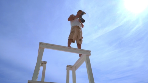 Photographer Taking Photo from Watchtower. Man Using Professional ...