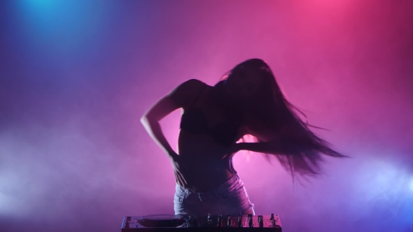 Girl DJ Starts Dancing Blue Pink Lights and a Lot of Smoke, Stock Footage