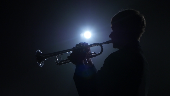 Instrumentalist Plays on a Trumpet Fast Melody. Studio in Smoke, Stock ...
