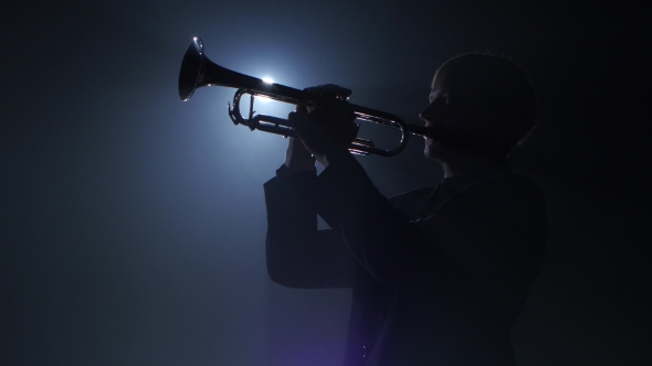 Trumpeter Plays a Wind Instrument Fast Melody. Studio in Smoke, Stock ...