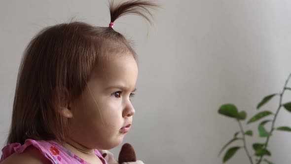 Small Toddler Girl Making Funny Expressive Grimace Face with Soft Toy ...