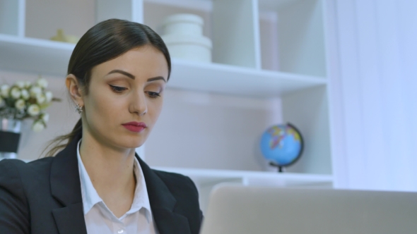 Tired Businesswoman Having a Headache While Working on Her Laptop in ...