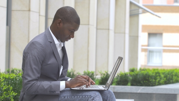 Happy African American Guy Displaying Computer Laptop on Outdoors ...
