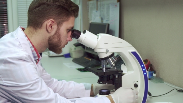 Man Looking Through the Microscope at the Laboratory, Stock Footage