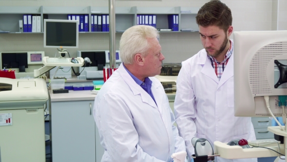 Two Men Look at the Monitor at the Laboratory, Stock Footage | VideoHive