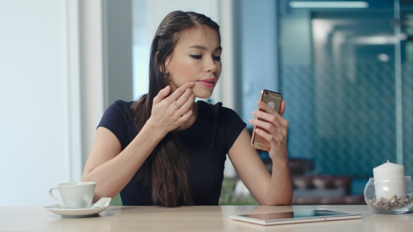 Pretty Young Girl Using Phone To Check Her Make Up and Take a Selfie ...