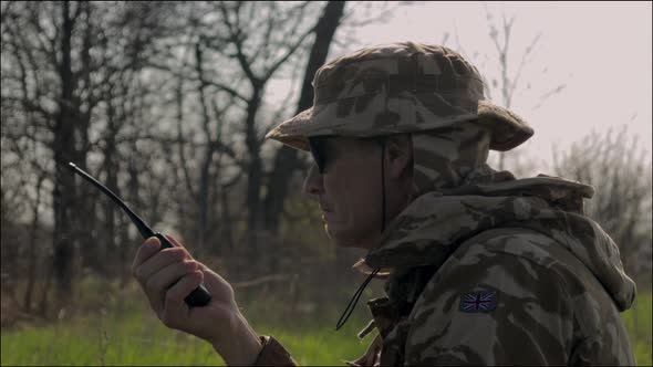 Man In A British Military Uniform Talking On The Radio, Stock Footage