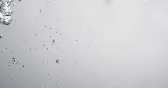 Bubbles Rising In Water As Liquid Is Poured Into It, Stock Footage
