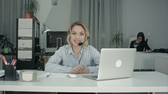 Smiling Female Consultant with Headset Presenting Company Services ...