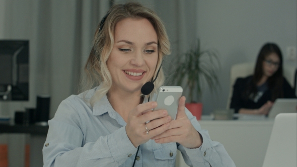 Smiling Office Woman Texting on the Phone at Her Workplace, Stock Footage