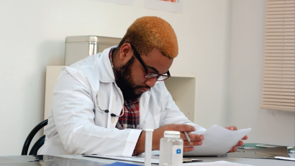 Overworked Male Doctor Falling Alseep Over Medical Papers at His Desk ...