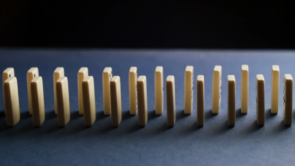 White Dominoes Falling in Chain Reaction. Domino Effect, Stock Footage