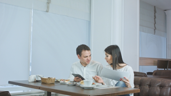 Two Colleagues Discussing Work While Eating Lunch in a Cafe, Stock Footage