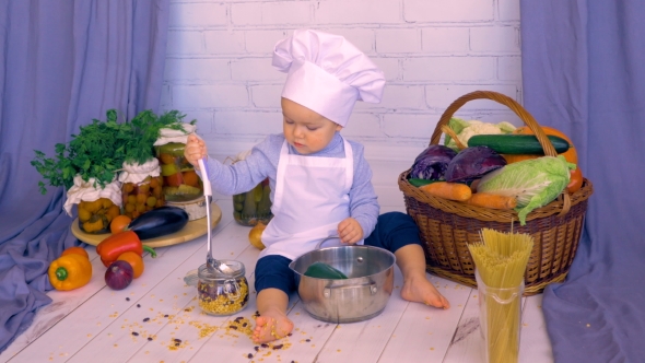 Adorable Baby Male Child in the Kitchen Cooking, Playing with Bank of ...