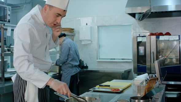 Head Chef Cooking in the Restaurant Kitchen While Having Phone ...