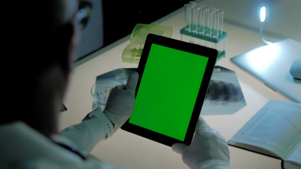 Doctor or Researcher Is Using Tablet PC with Green Screen in Modern ...