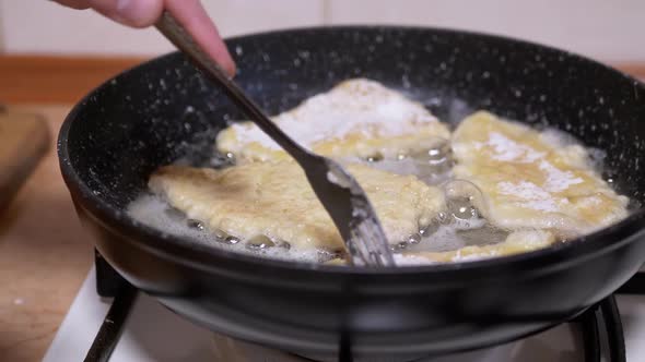 Female Hand Flips Chicken Chops on Hot Frying Pan with Wooden Spatula ...
