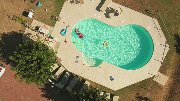 Rotating Drone Footage of Family Enjoying in Swimming Pool, Stock Footage