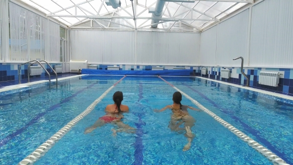 Two Young Women Talking and Swimming in the Pool, Stock Footage | VideoHive