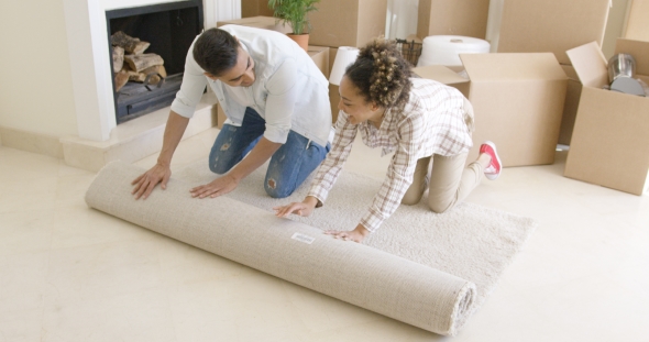 Young Couple Rolling Up a Rug As They Move House, Stock Footage | VideoHive