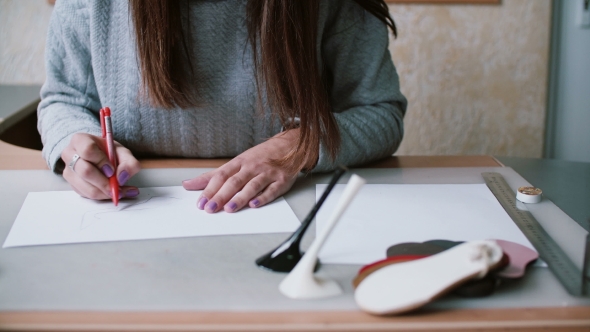 Woman Holding Pencil, Sitting at the Table and Drawing Sketch on Paper ...