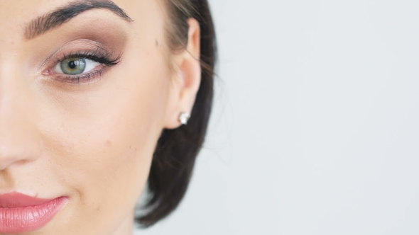 Portrait of Half Face of Saucy Girl Smiling. Slowly, Stock Footage