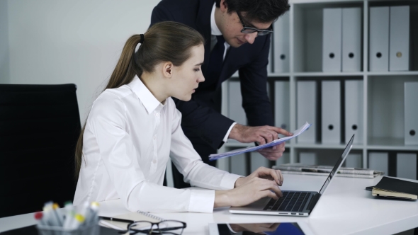 Two Colleagues Are Checking Details at Notepad and Laptop., Stock Footage
