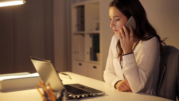Woman with Laptop Calling on Smartphone at Office 11, Stock Footage