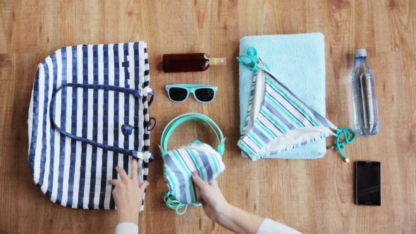 Hands Packing Beach Accessories To Bag 20, Stock Footage | VideoHive