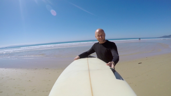 Smiling Surfer Walking Out of Sea, Stock Footage | VideoHive