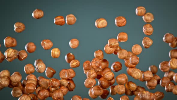 Super Slow Motion Shot of Flying Hazelnuts After Being Exploded on Grey ...