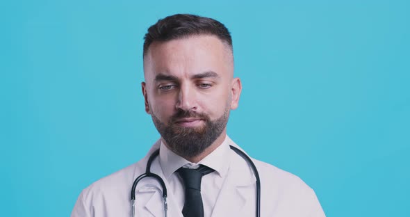 Serious Medical Doctor Shaking Head No After Contemplating, Blue Studio ...
